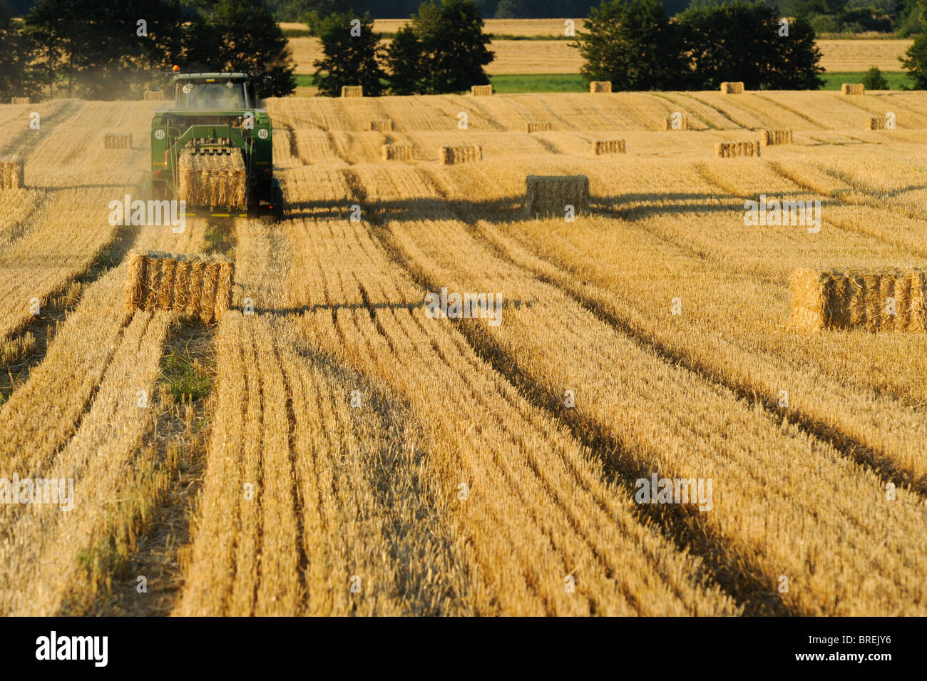 Germany John Deere tractor and bale press at straw harvest Stock Photo ...