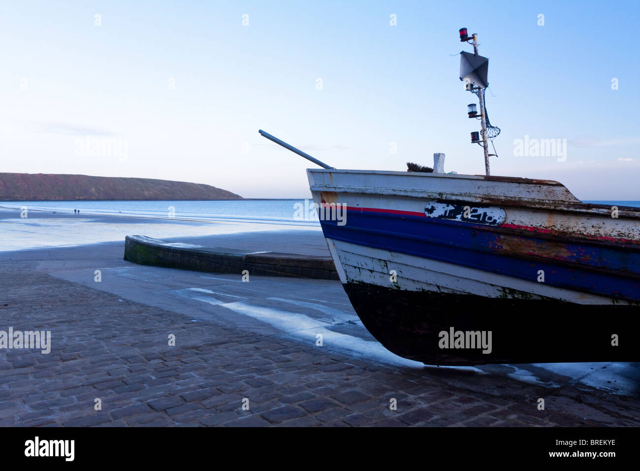 Traditional fishing boats on the beach at Filey in North Yorkshire ...