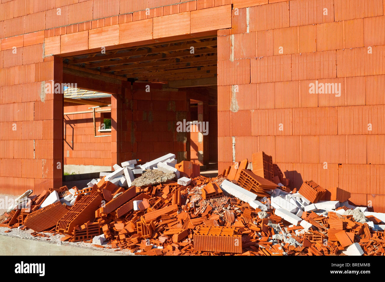Broken, scrapped clay roof tiles and building materials on building ...