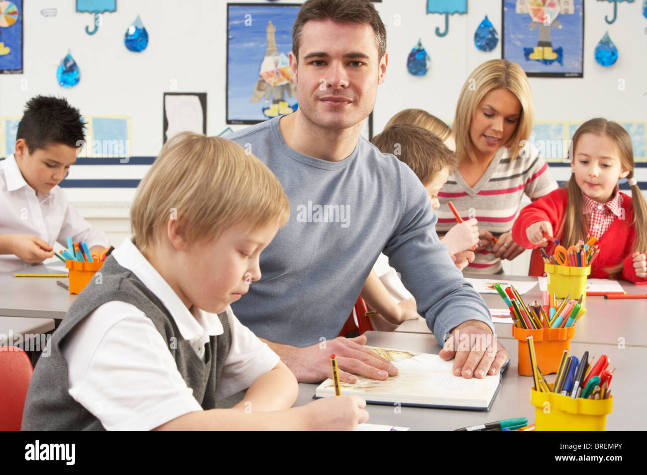 Group Of Primary Schoolchildren And Teacher Having lesson In Classroom ...