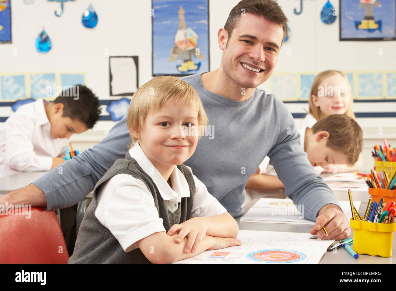 Group Of Primary Schoolchildren And Teacher Having lesson In Classroom ...