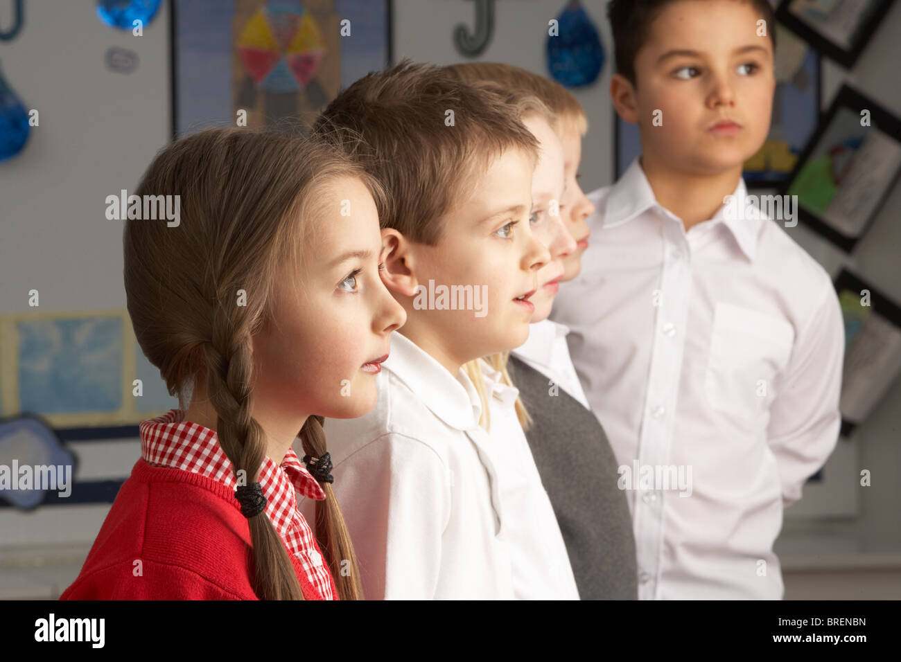 Portrait Of Group Of Primary Schoolchildren Standing In Classroom Stock ...