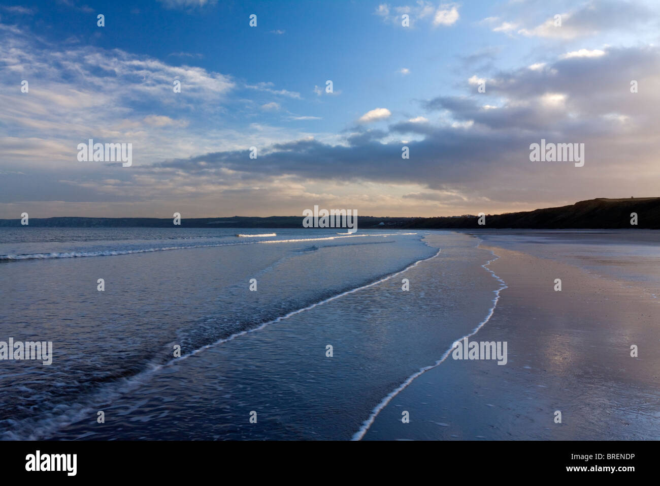 Sunset and clouds reflected on the sandy beach at Filey in North ...