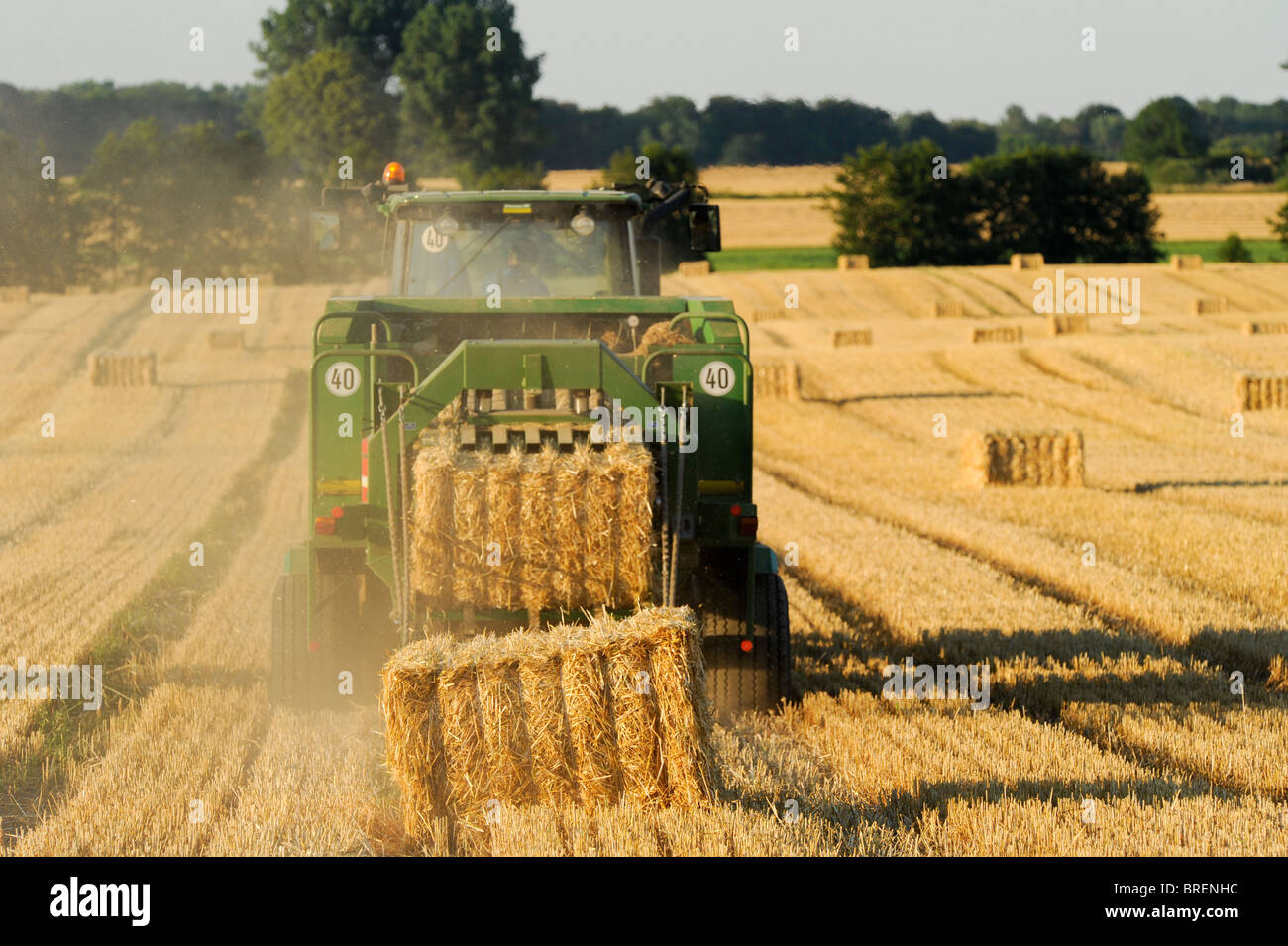 Germany John Deere tractor and bale press at straw harvest Stock Photo ...