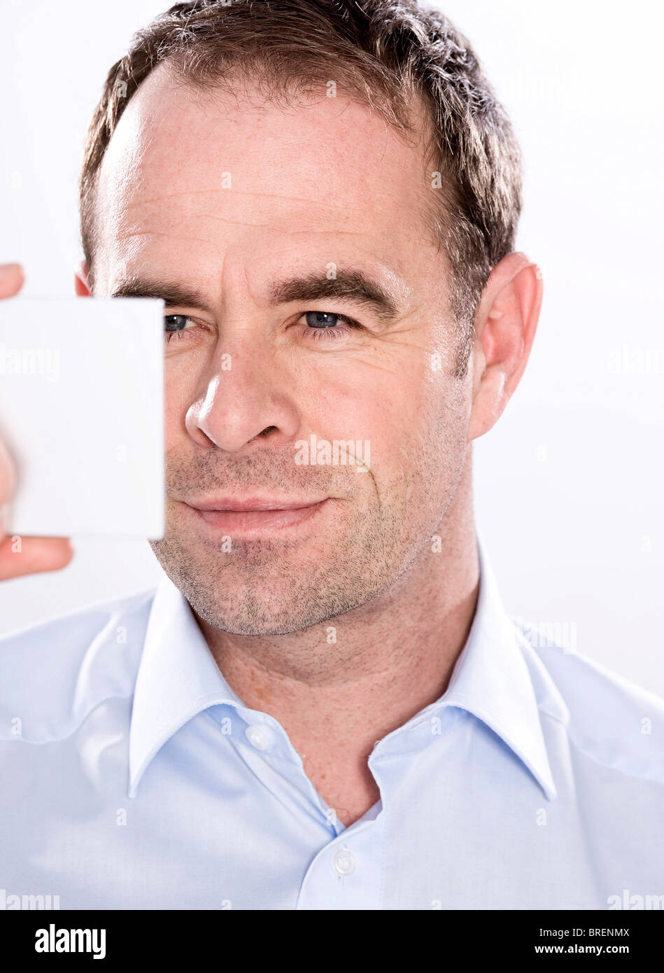 Man looking into a mirror Stock Photo - Alamy