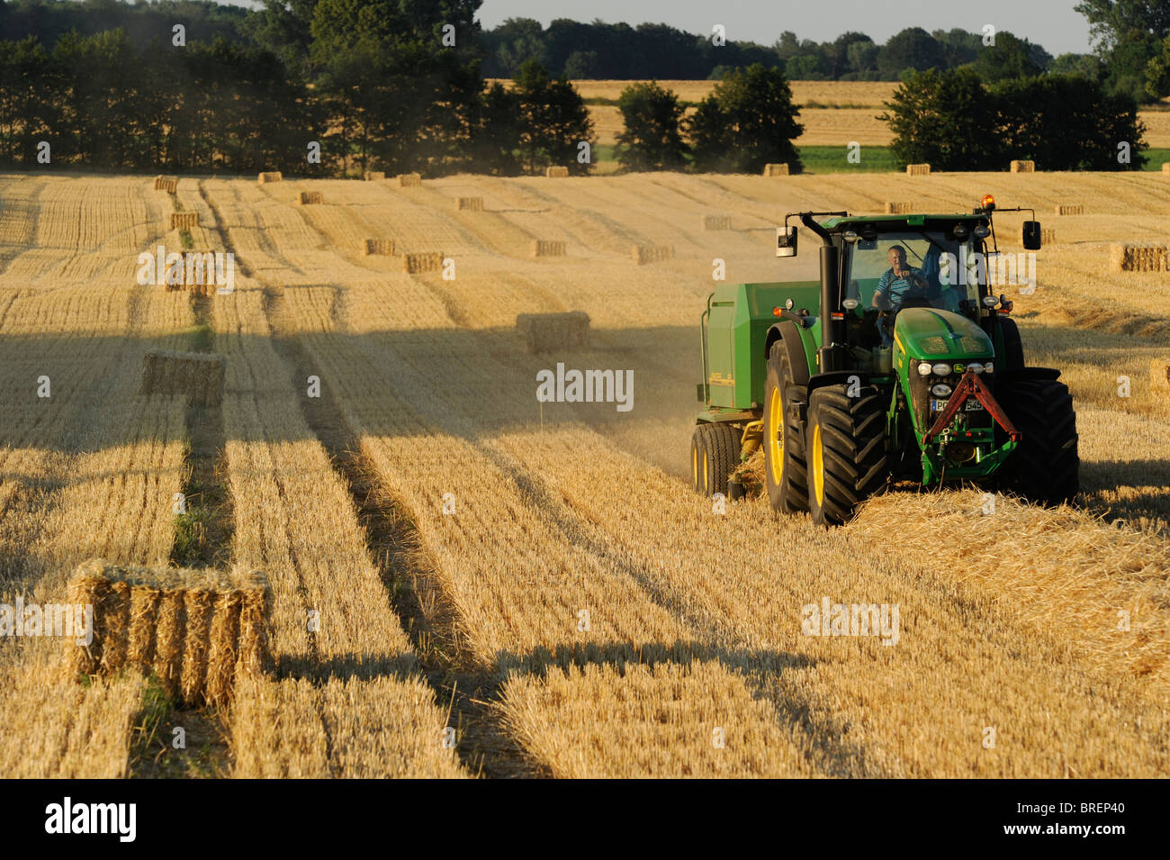 Germany John Deere tractor and bale press at straw harvest Stock Photo ...