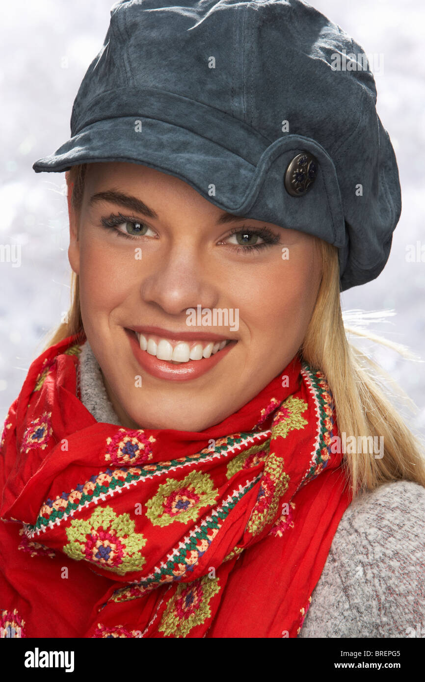 Fashionable Teenage Girl Wearing Cap And Knitwear In Studio In Front Of ...