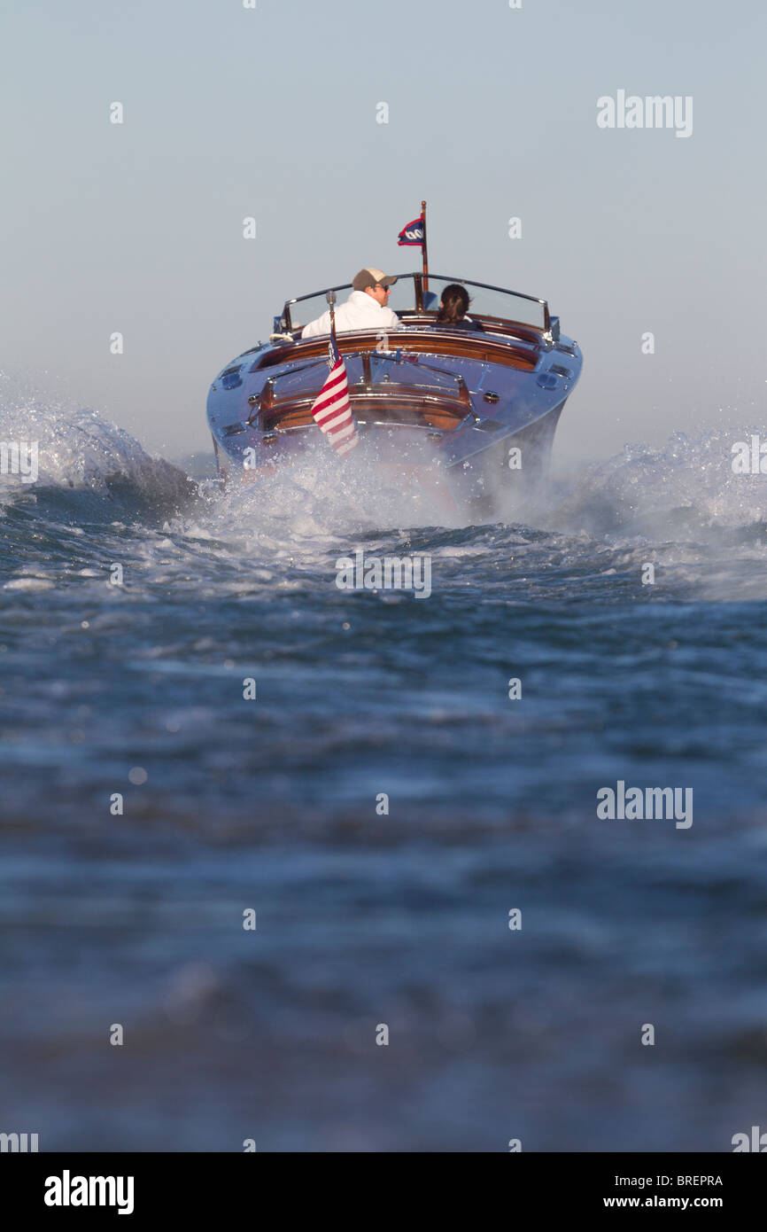 The stern of a departing antique, wooden Gar Wood boat Stock Photo - Alamy