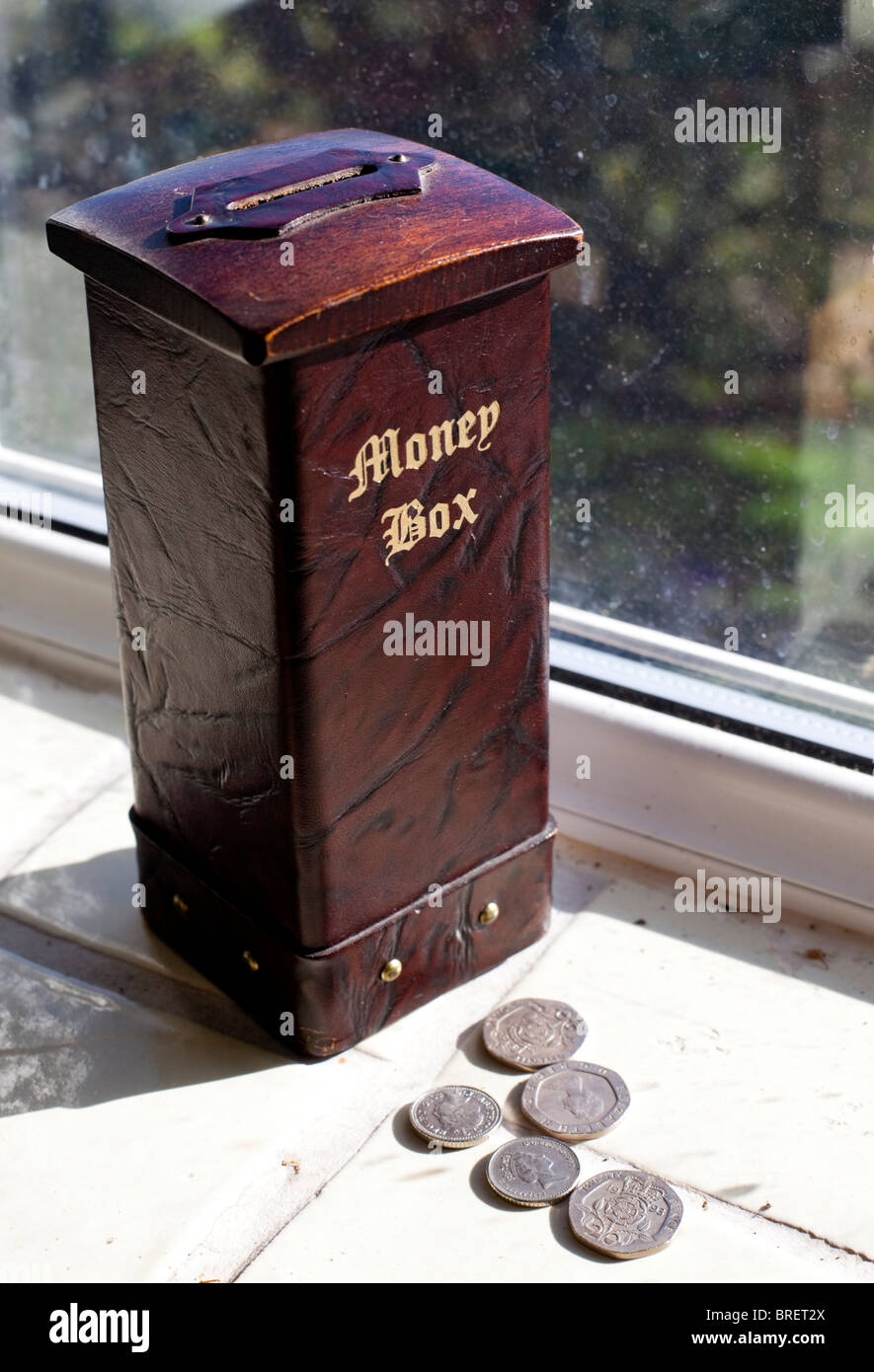 Money box by a window Stock Photo - Alamy