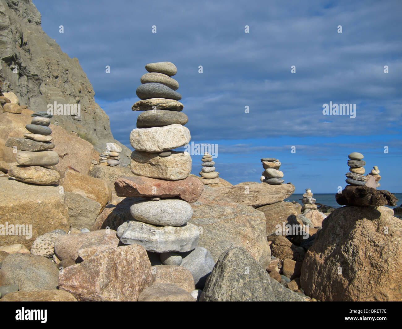 rock cairns at sunset on rocky beach Stock Photo - Alamy