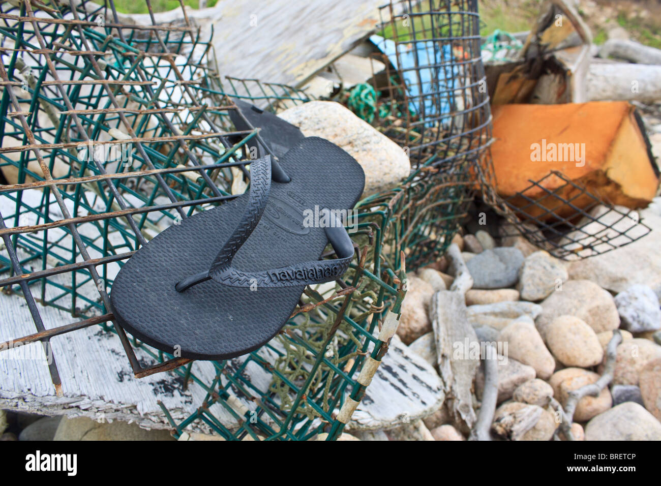 flip flop in a pile of beach junk Stock Photo - Alamy