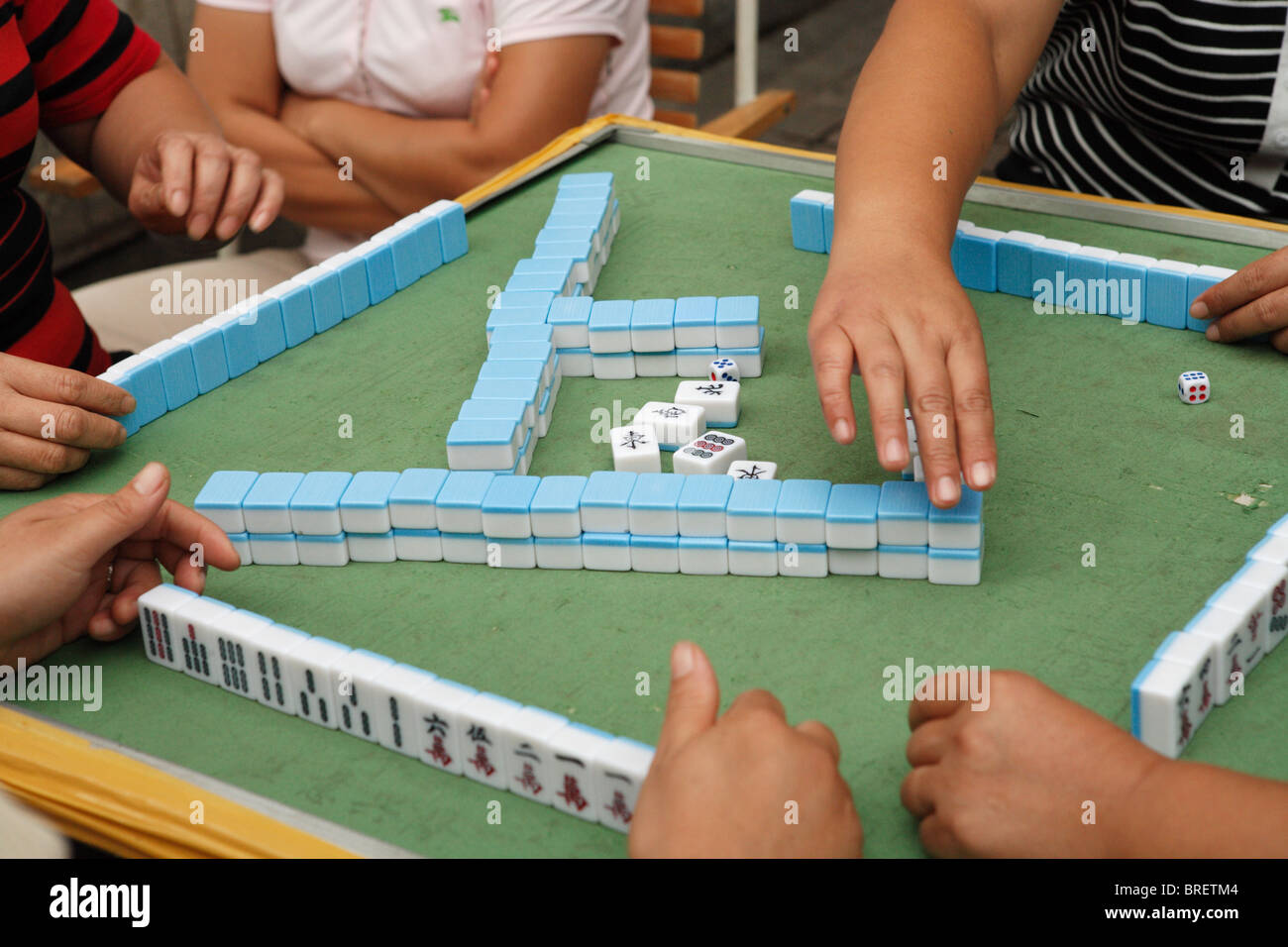 A Mahjong game in progress on a street in Shanghai, China Stock Photo ...