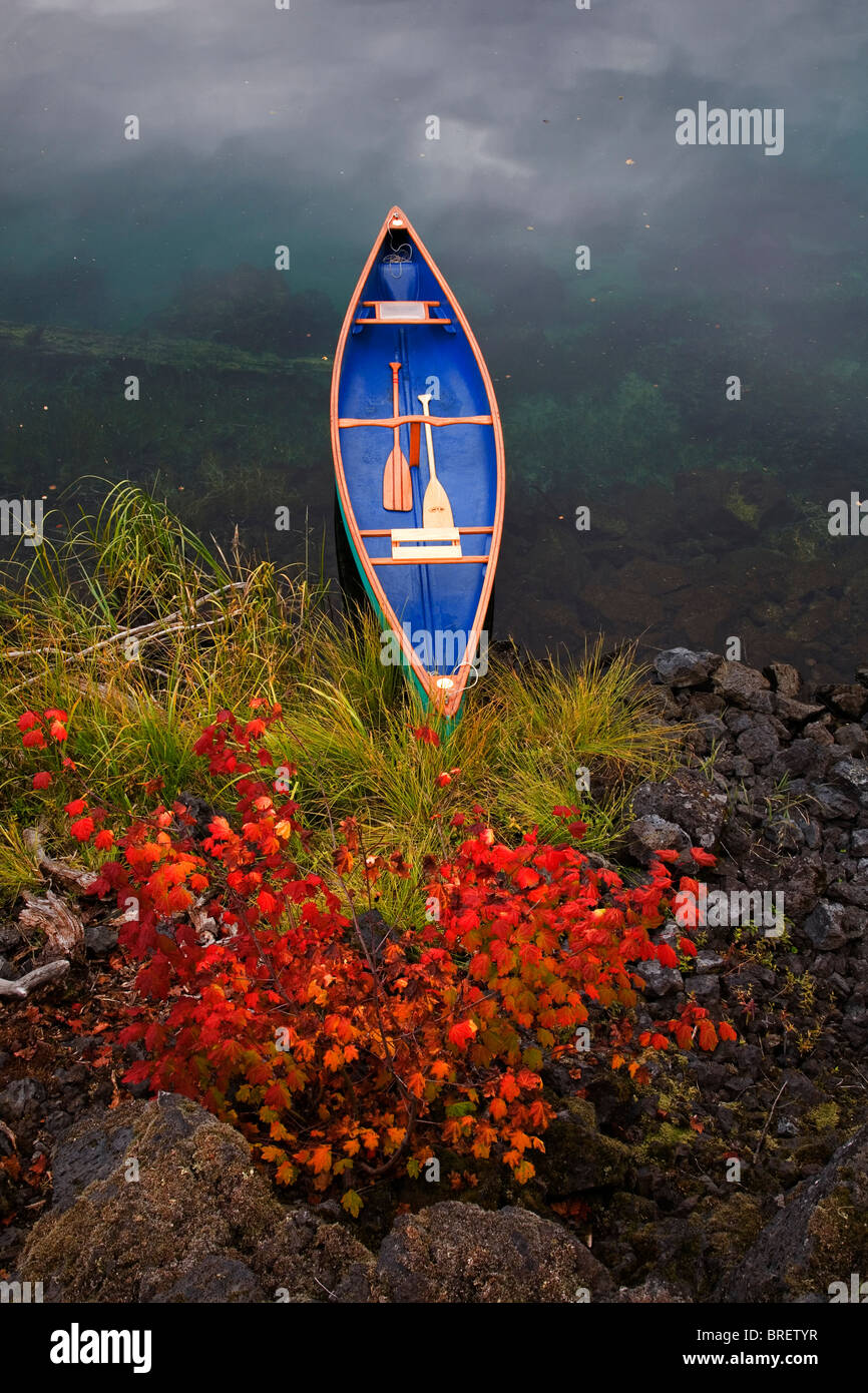 A canoe on the bank of Clear Lake in the Oregon Cascades on an autumn ...