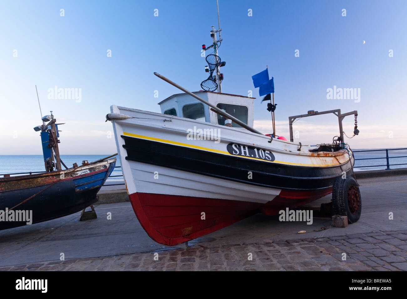 Traditional fishing boats on the beach at Filey in North Yorkshire ...