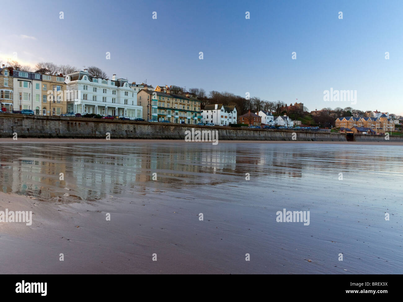 Houses and hotels reflected on the sandy beach at Filey in North ...