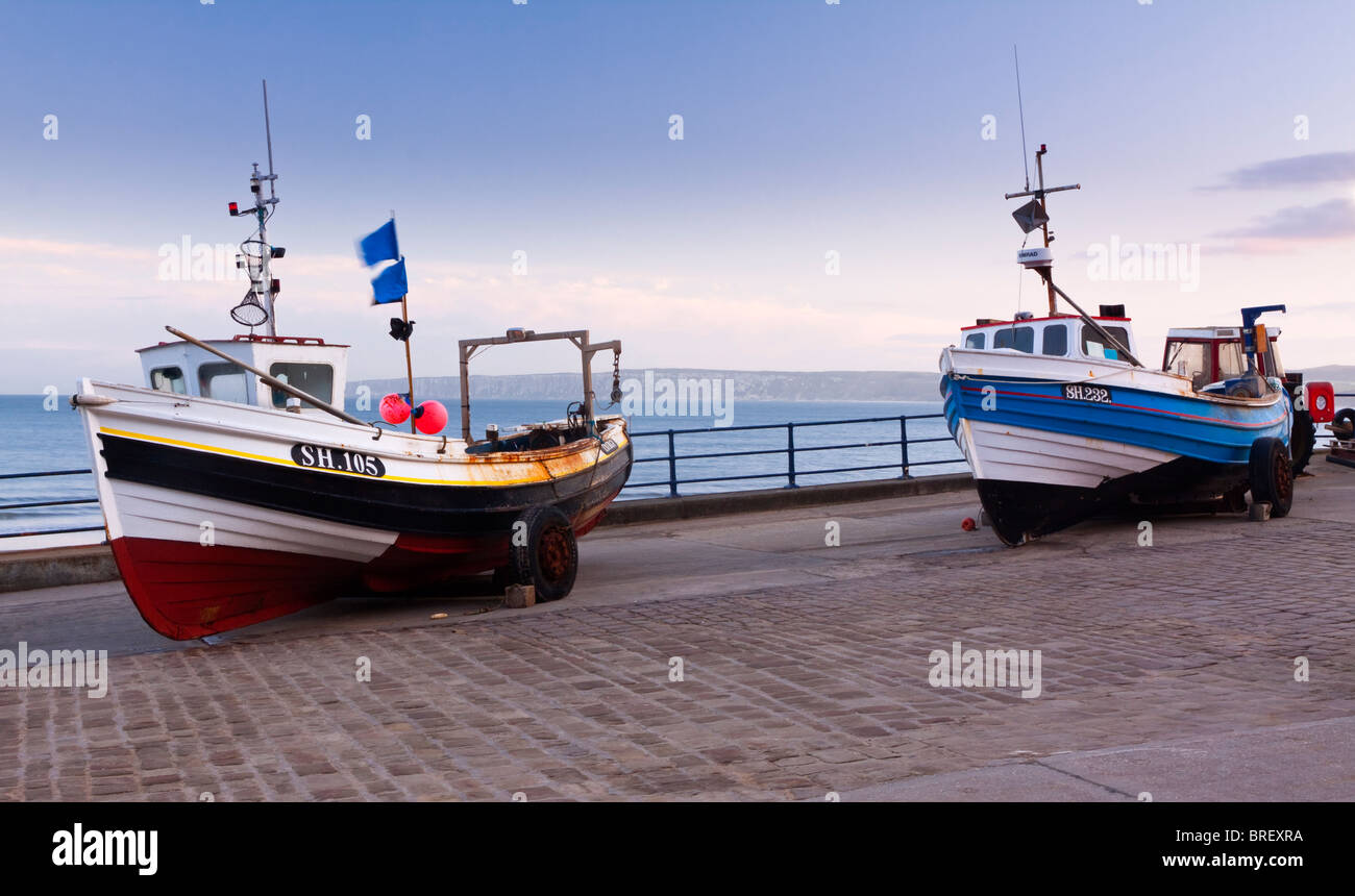 Traditional fishing boats on the beach at Filey in North Yorkshire ...