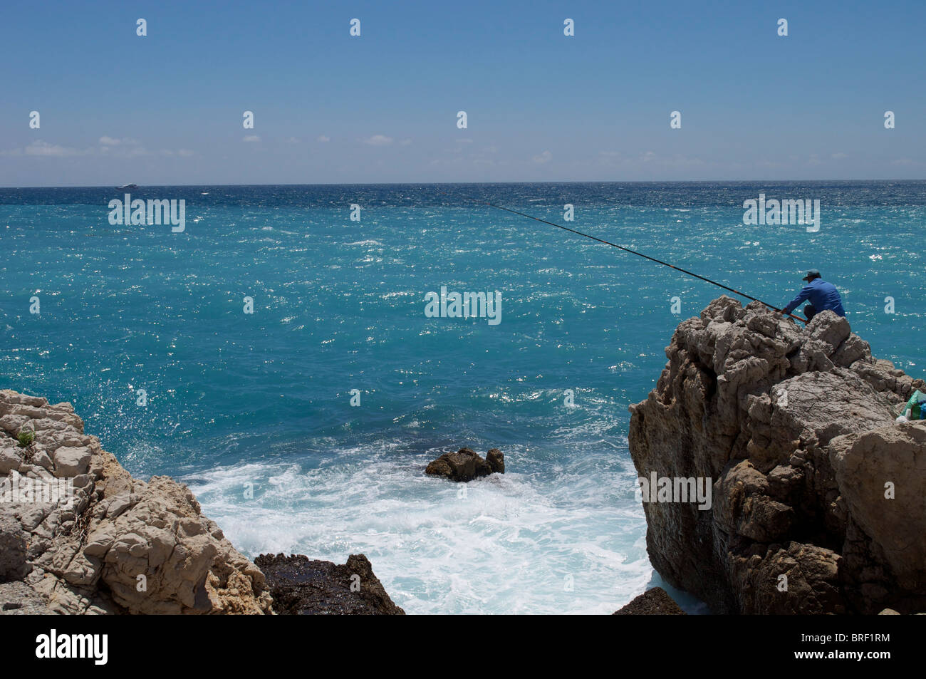 Fisherman rock fishing Mediterranean Sea Stock Photo - Alamy