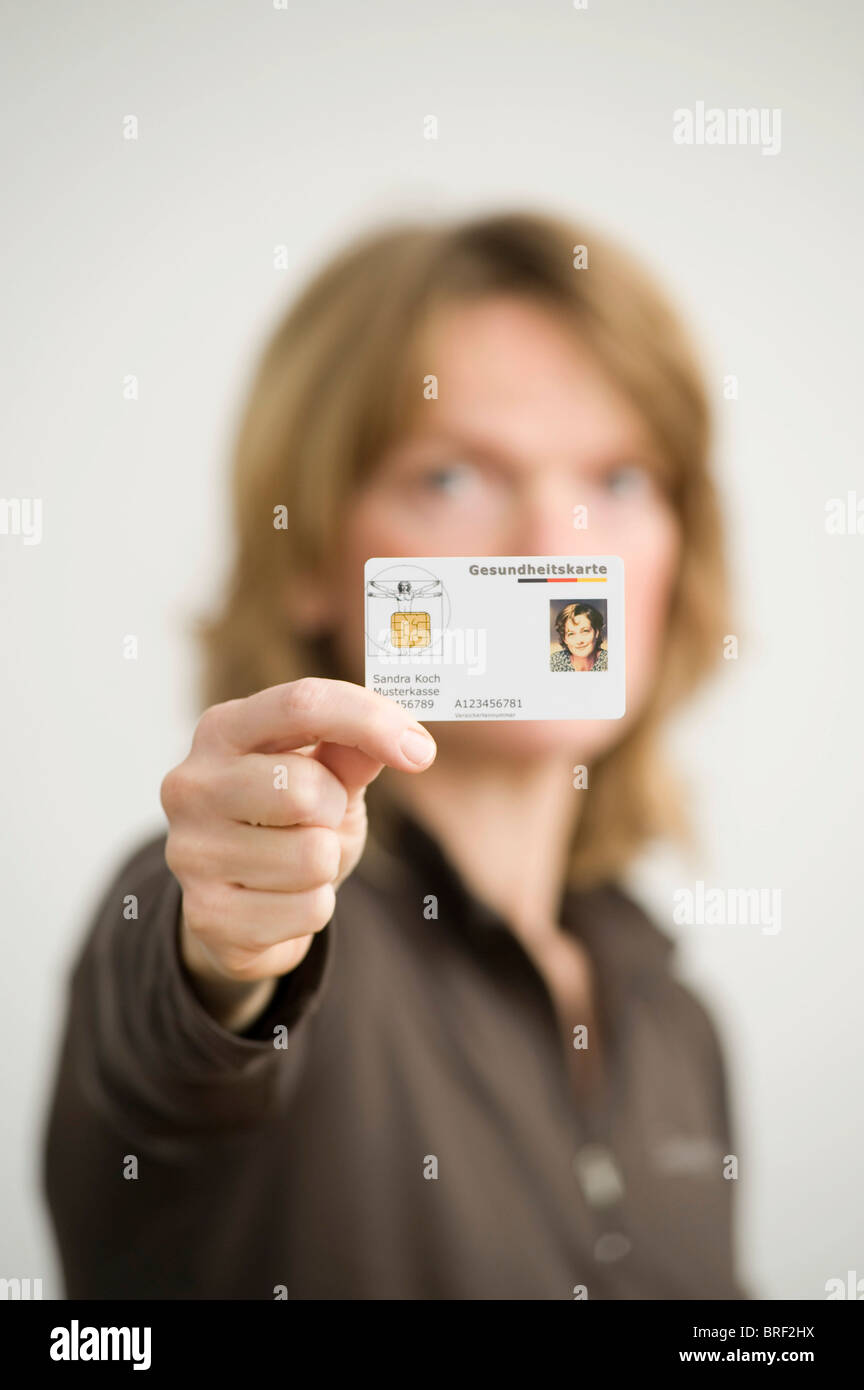Woman holding a German electronic health insurance card Stock Photo - Alamy