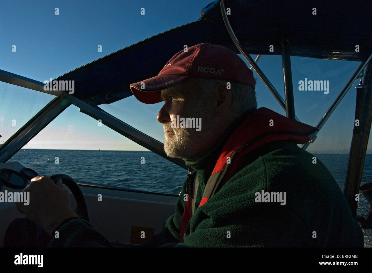 Man Driving boat Stock Photo - Alamy