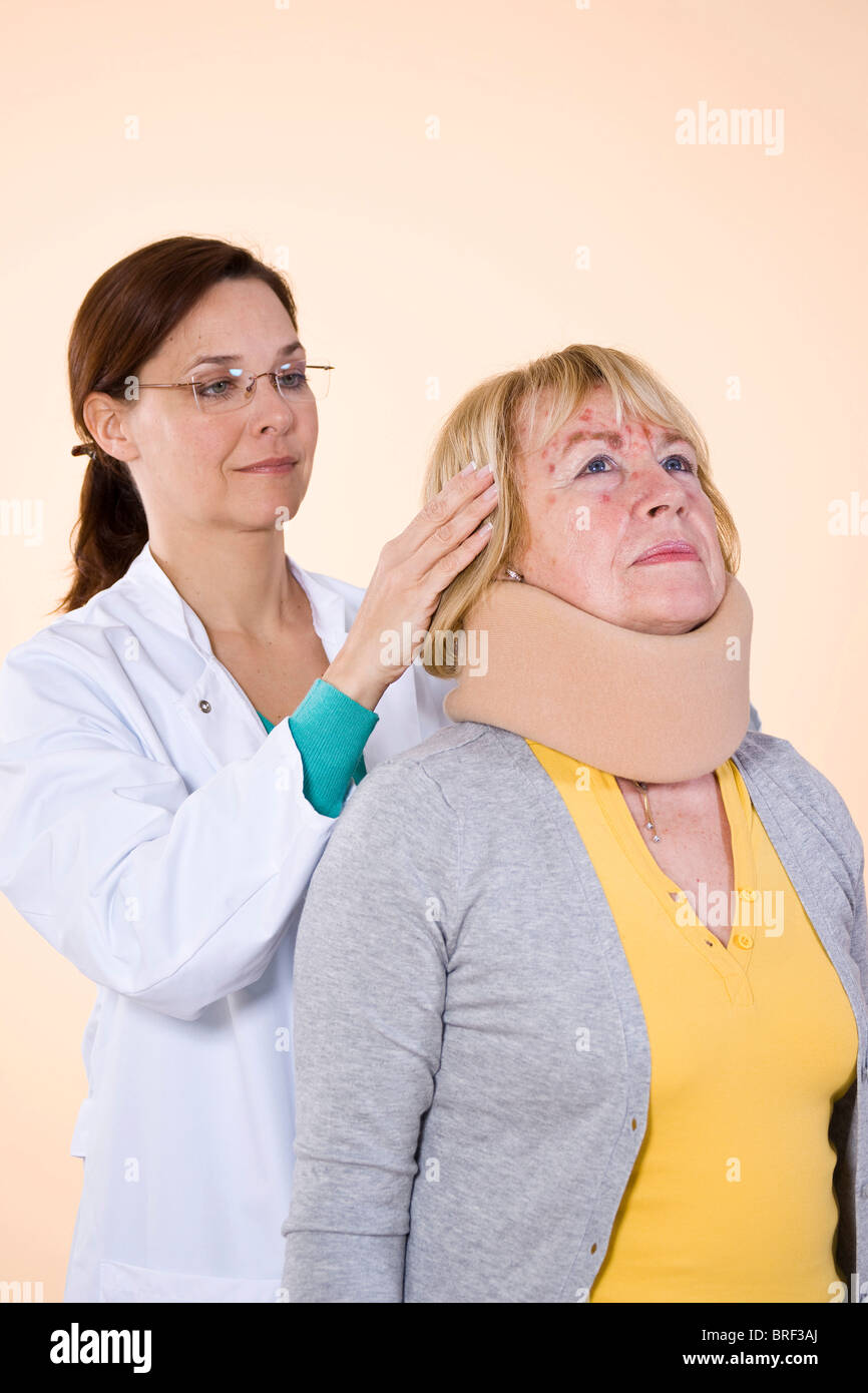 Doctor examining a patient with a neck brace Stock Photo - Alamy