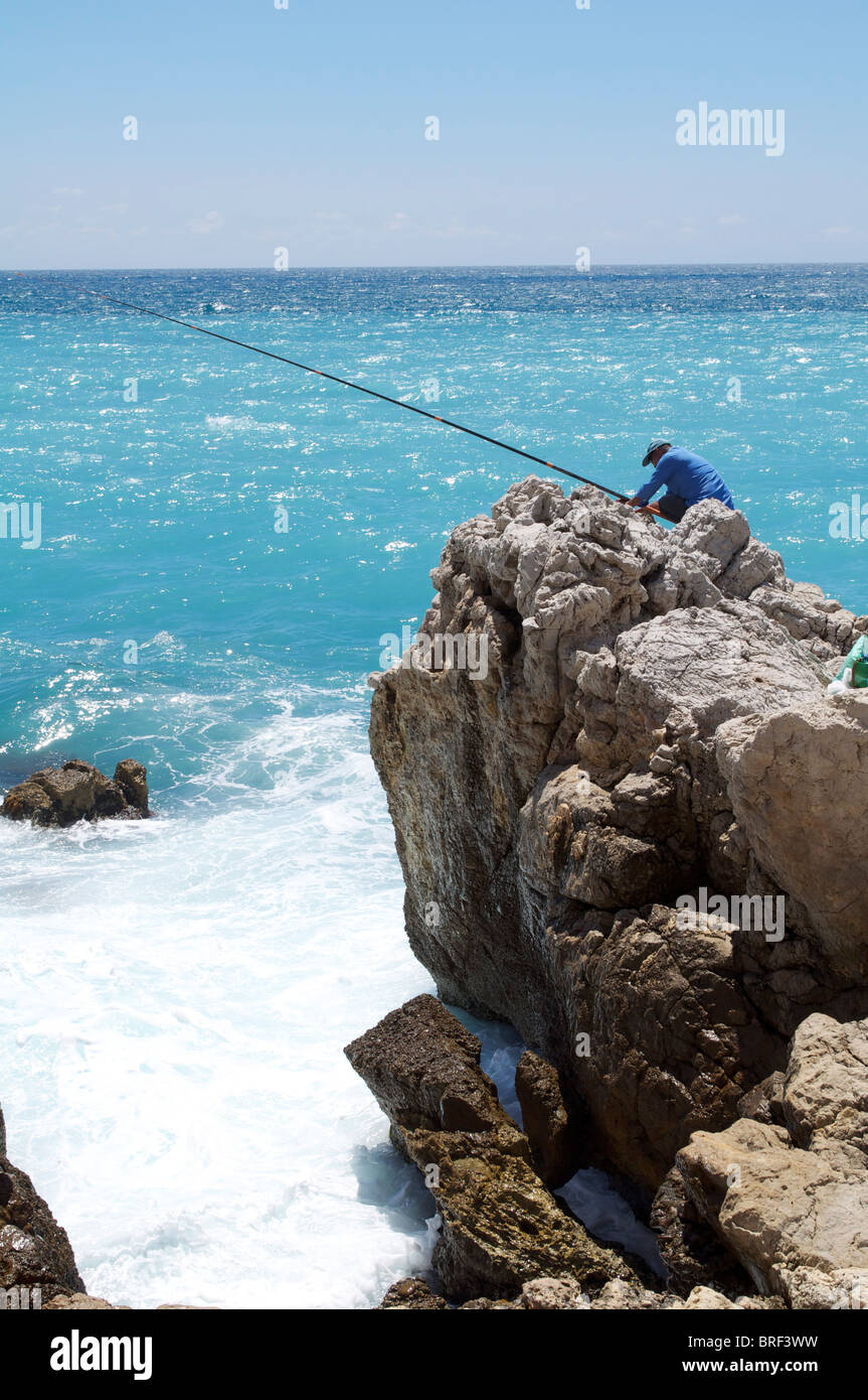 Fisherman rock fishing Mediterranean Stock Photo - Alamy
