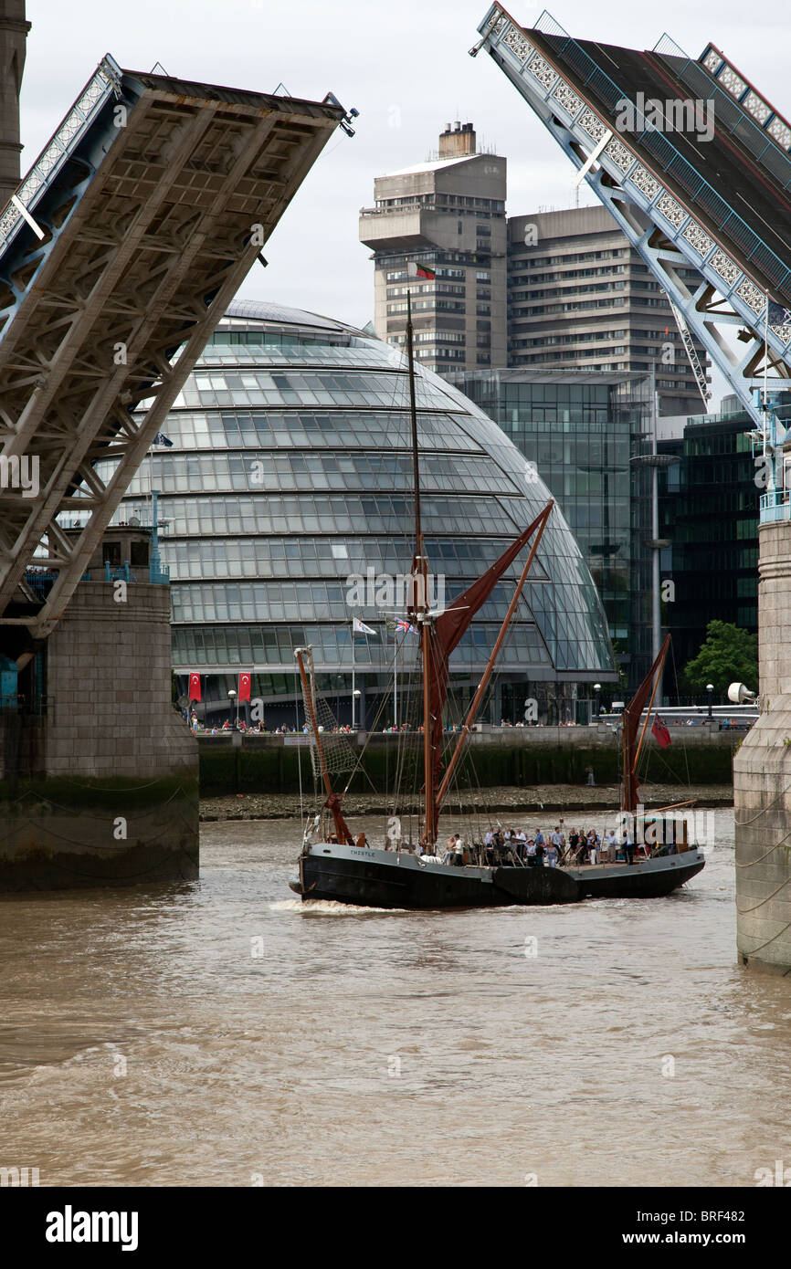 Traditional sailing barge passes through Tower Bridge under raised ...