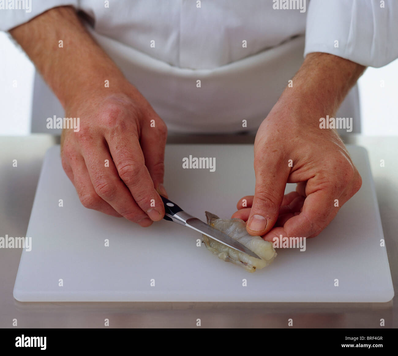 Man butterflying prawn, close-up Stock Photo - Alamy