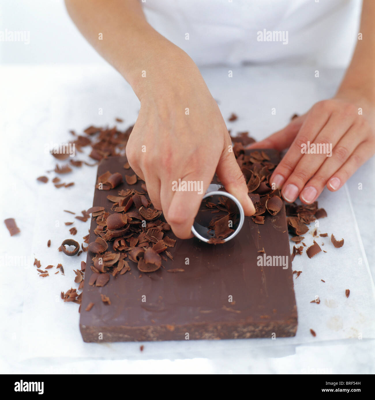 Shaving slab of chocolate Stock Photo - Alamy