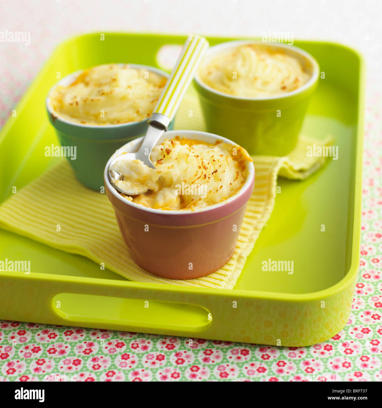 Children's food of mini fish pies on tray with spoon and napkin Stock ...