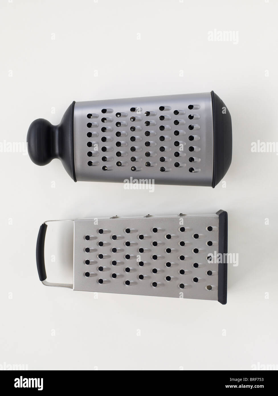 Two cheese graters on white background, close-up Stock Photo - Alamy