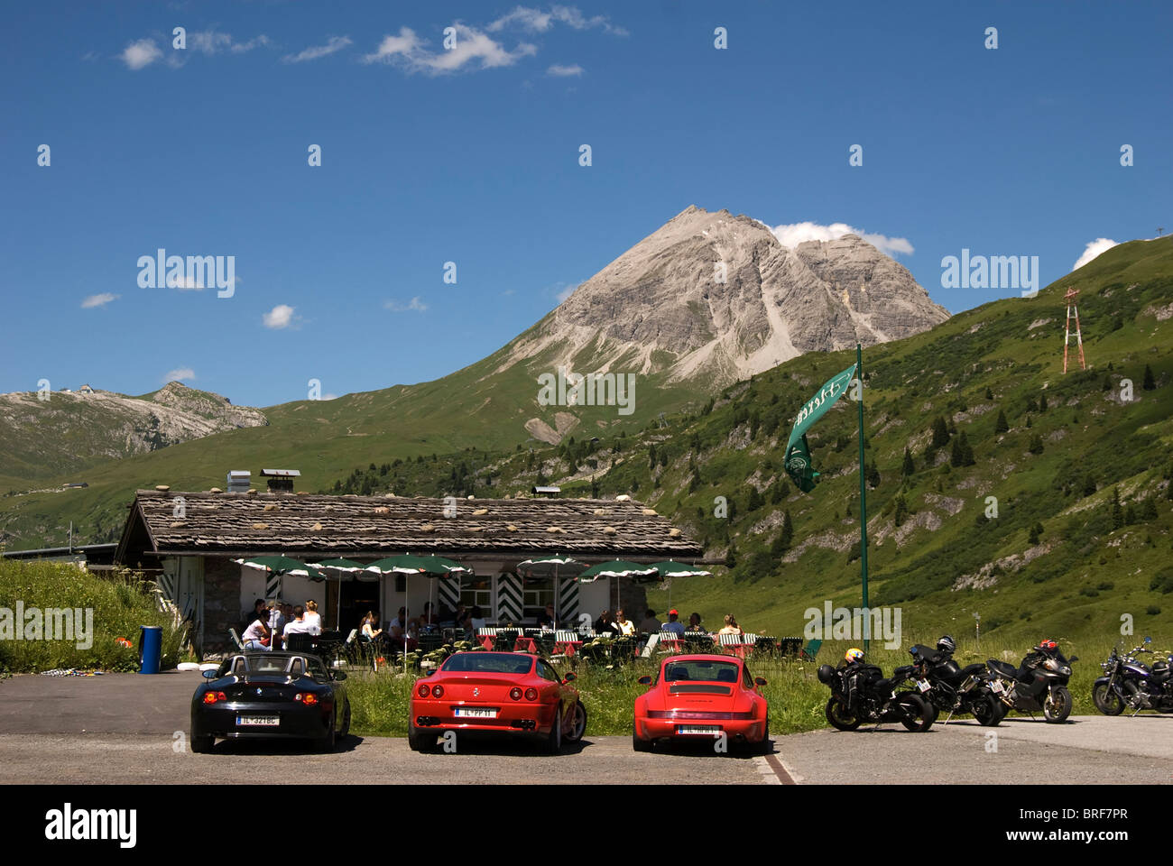 Flexen pass at Arlberg Range, sports car in front of cabin, mountains ...