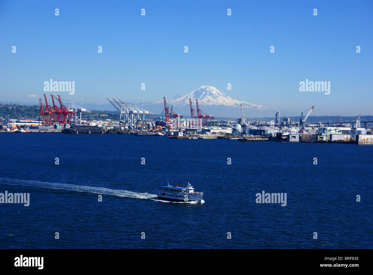 Seattle waterfront - dockyard cranes; Mt. Rainier in background Stock ...