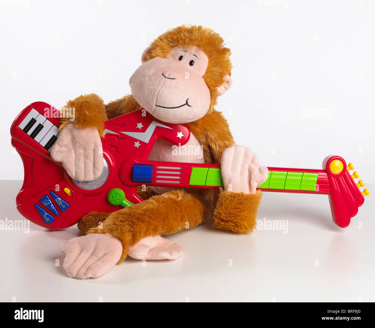 Toy monkey playing guitar, close-up Stock Photo - Alamy
