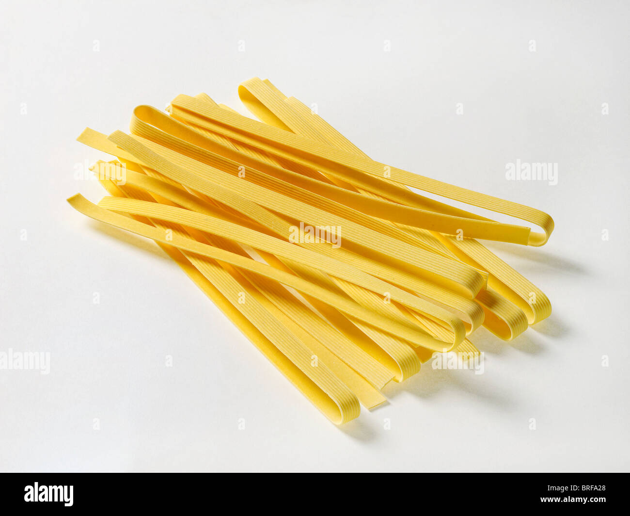 Parpadelle pasta against white background Stock Photo - Alamy