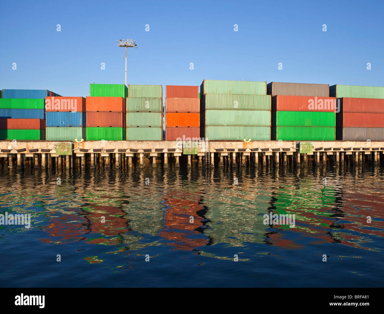 Piles of colorful shipping containers in warm sunset light Stock Photo ...