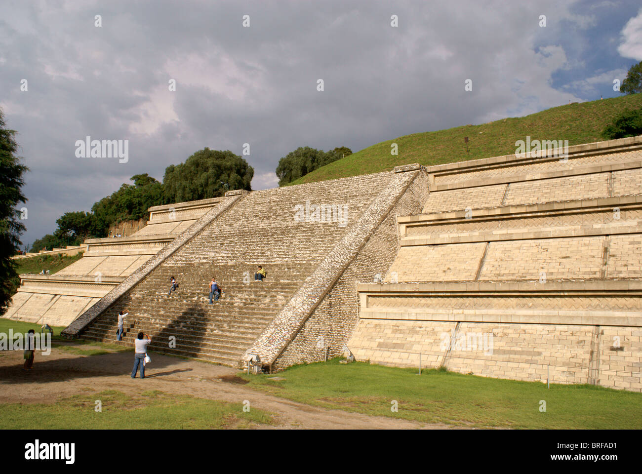 People climbing the reconstructed base of Tepanapa Pyramid's west side ...