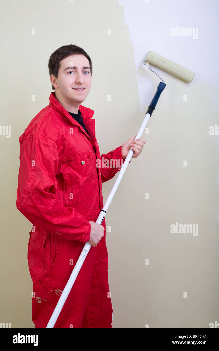 Man painting a wall Stock Photo - Alamy