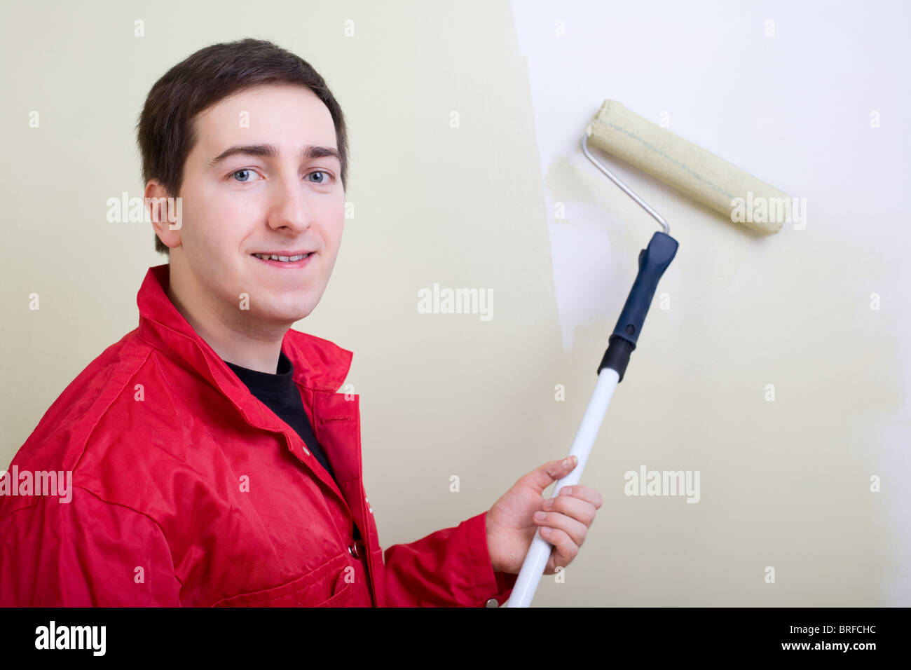 Man painting a wall Stock Photo - Alamy