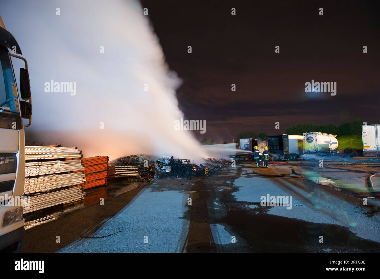 Pile of pallets at factory on fire at night Stock Photo - Alamy