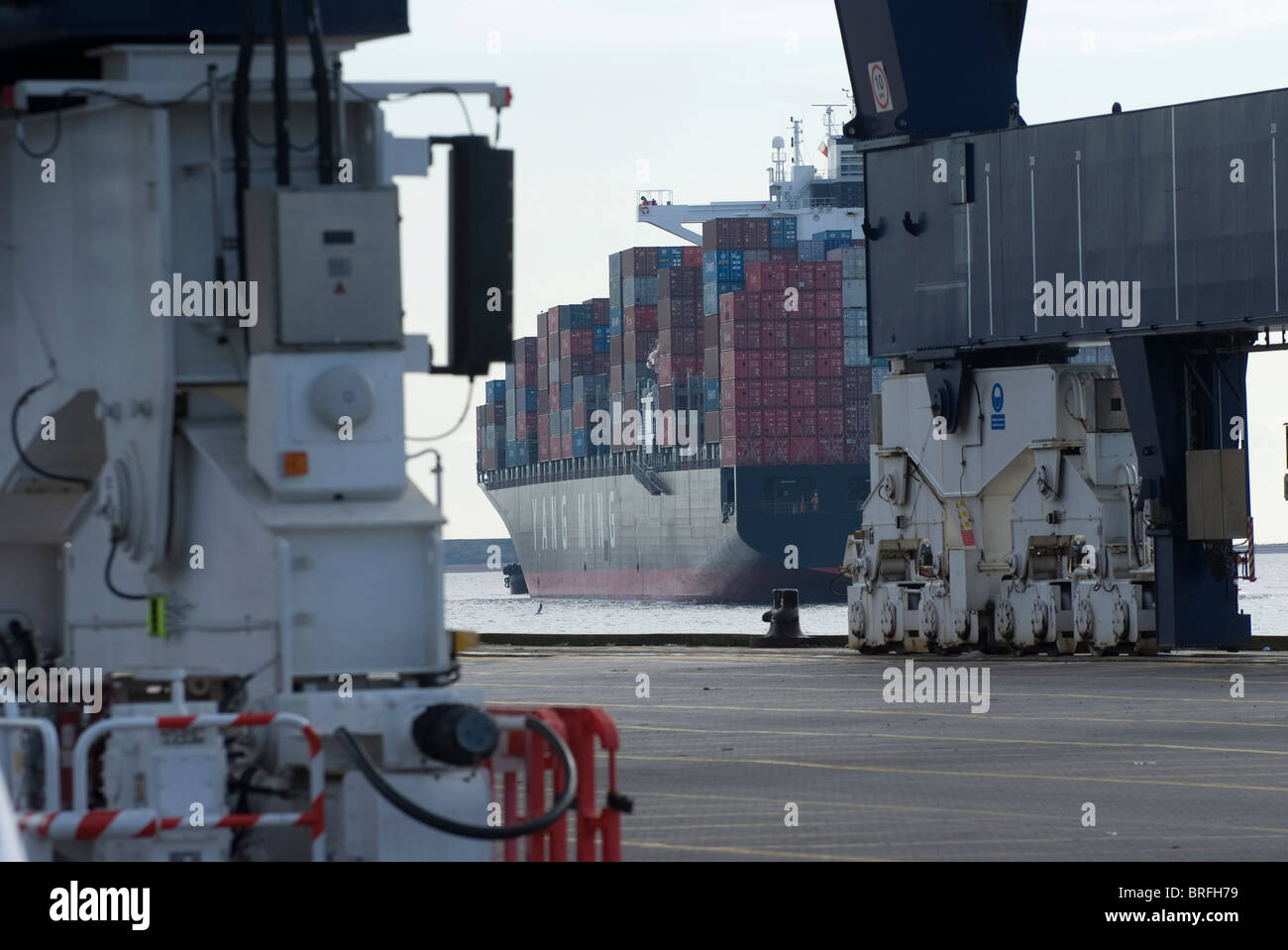 Container ship and straddle carriers at port Stock Photo - Alamy