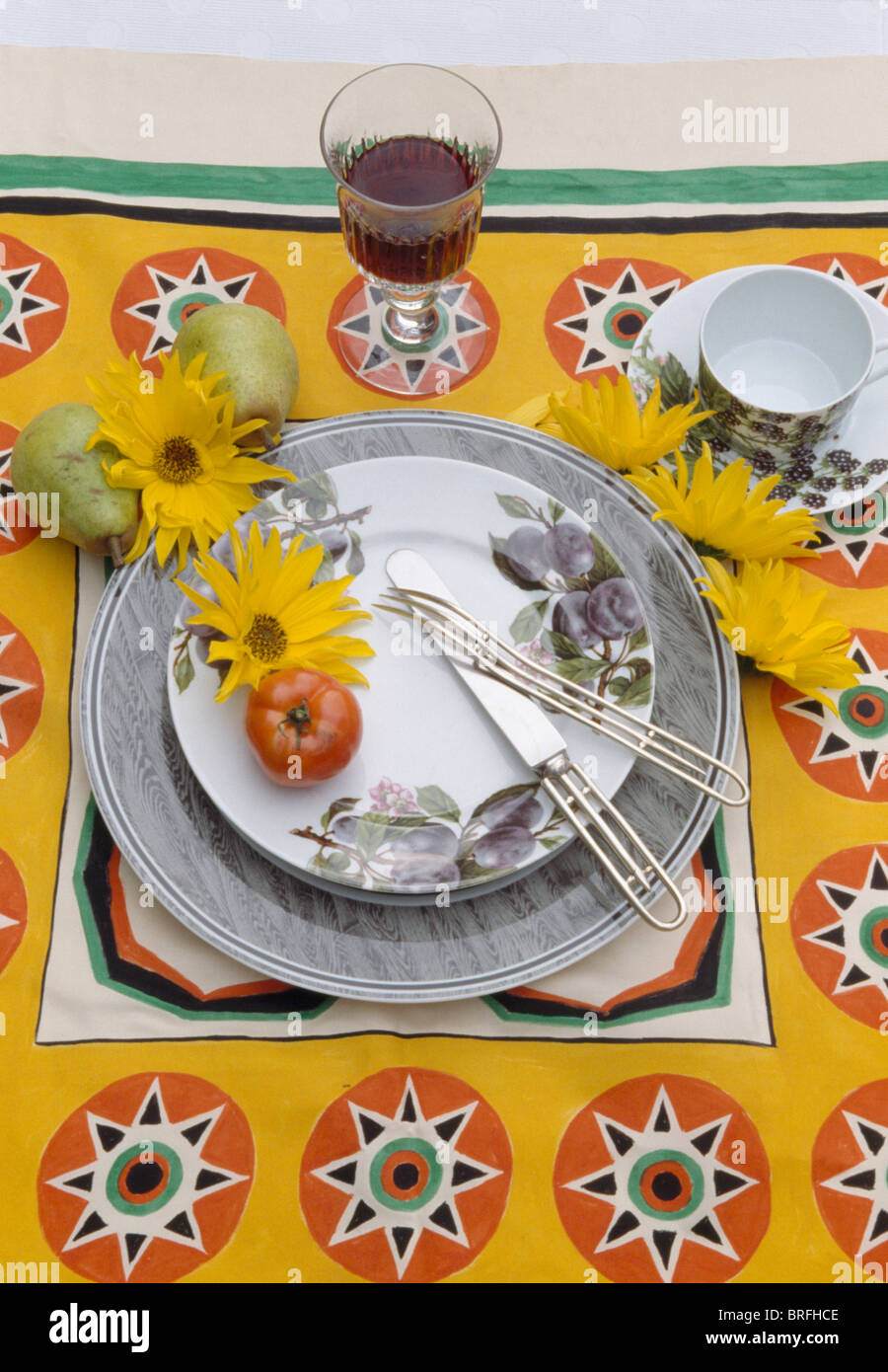 Close-up of table with patterned yellow cloth and gray crockery Stock ...