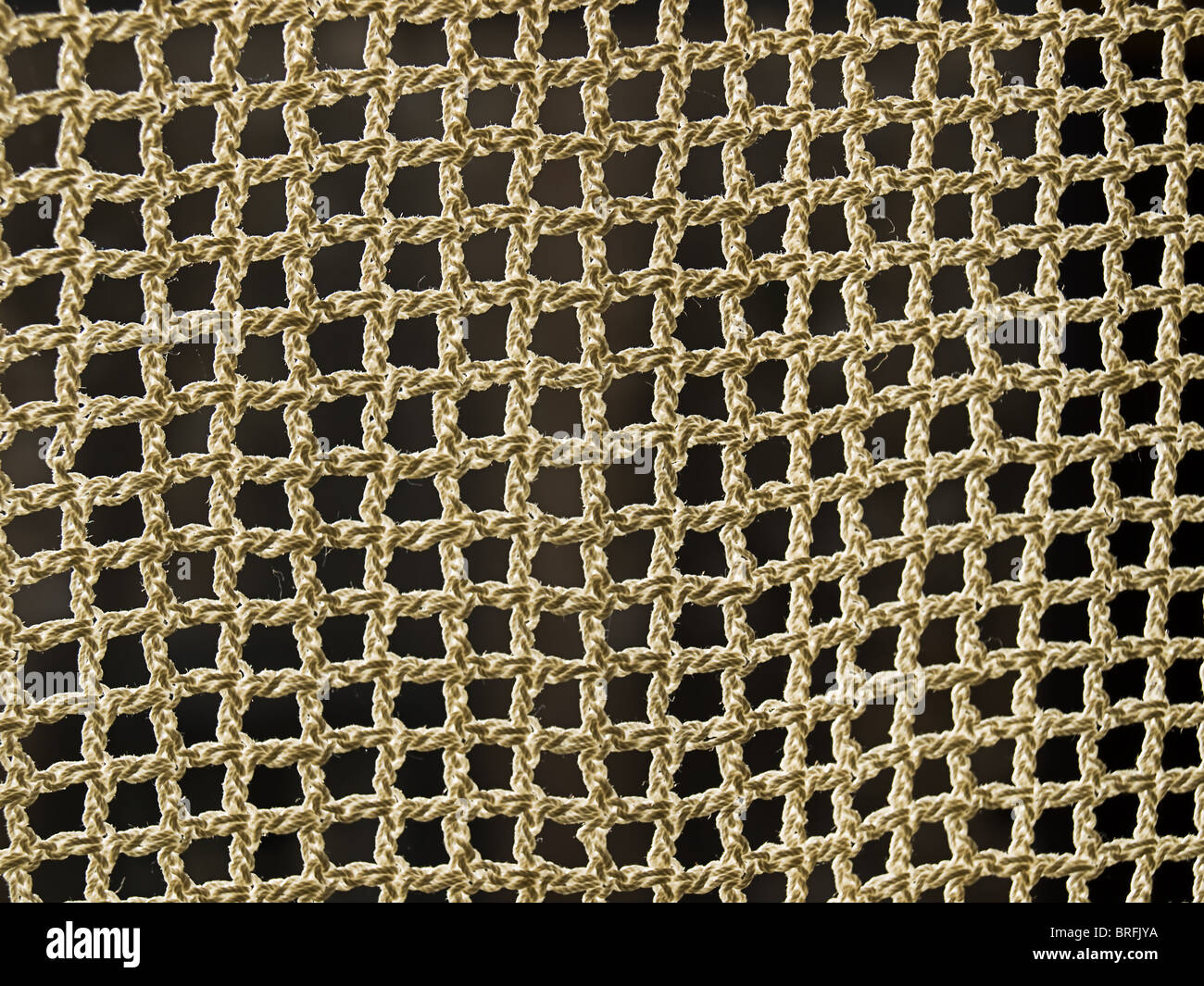 Threadlike net with a back light and dark background Stock Photo - Alamy
