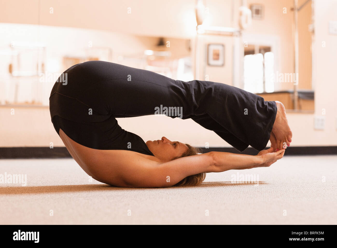 Woman Executing Flexible Pose in Pilates Class Stock Photo - Alamy