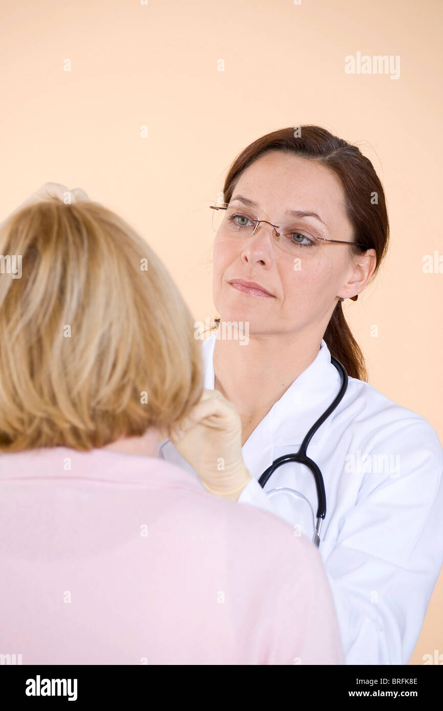 Doctor examining a patient's face Stock Photo - Alamy