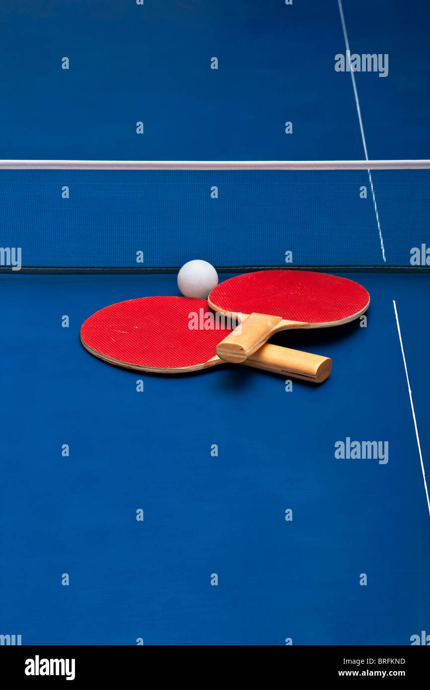 Pair of table tennis rackets on top of a blue playing field Stock Photo ...