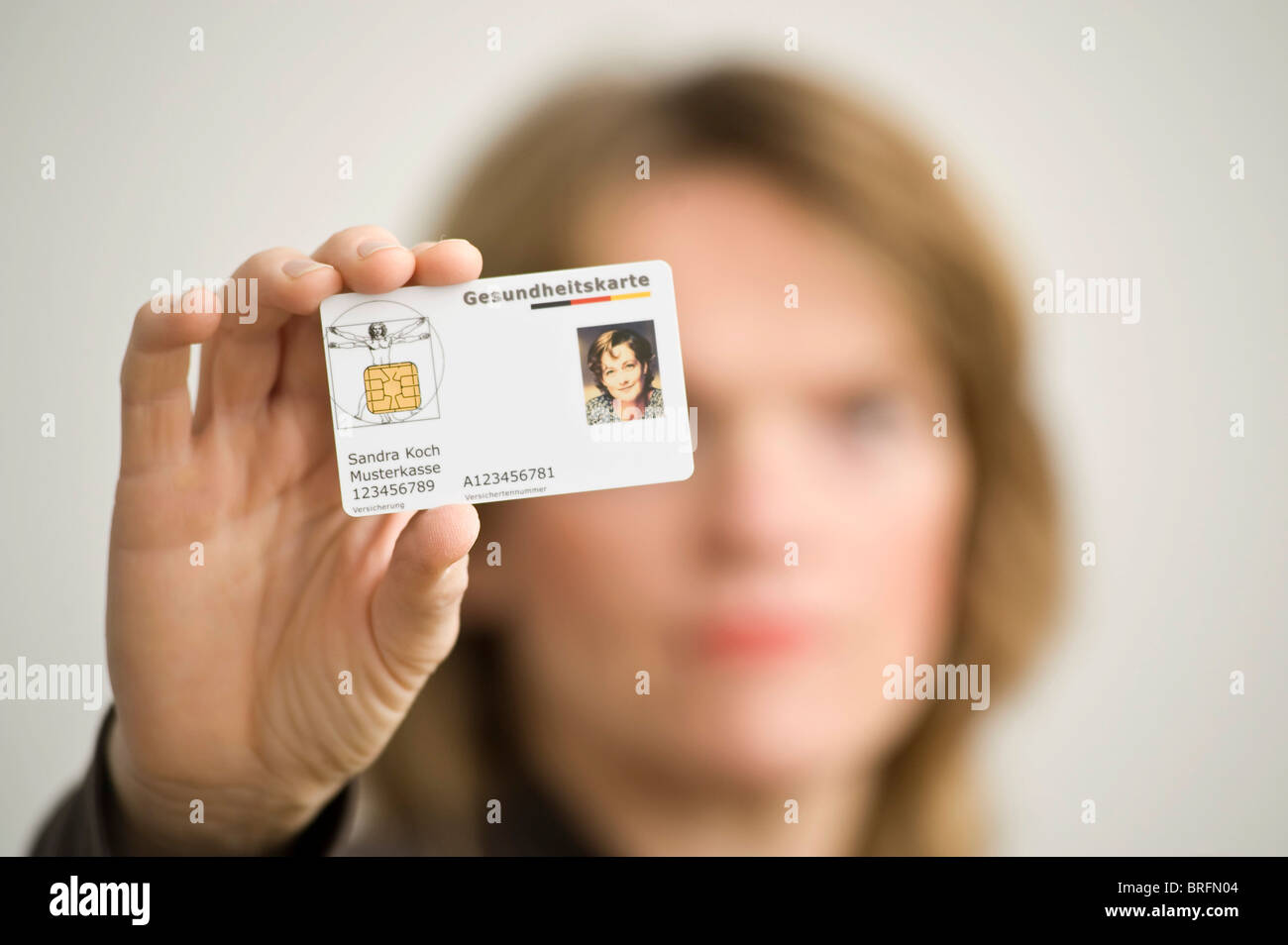 Woman holding a German electronic health insurance card Stock Photo - Alamy