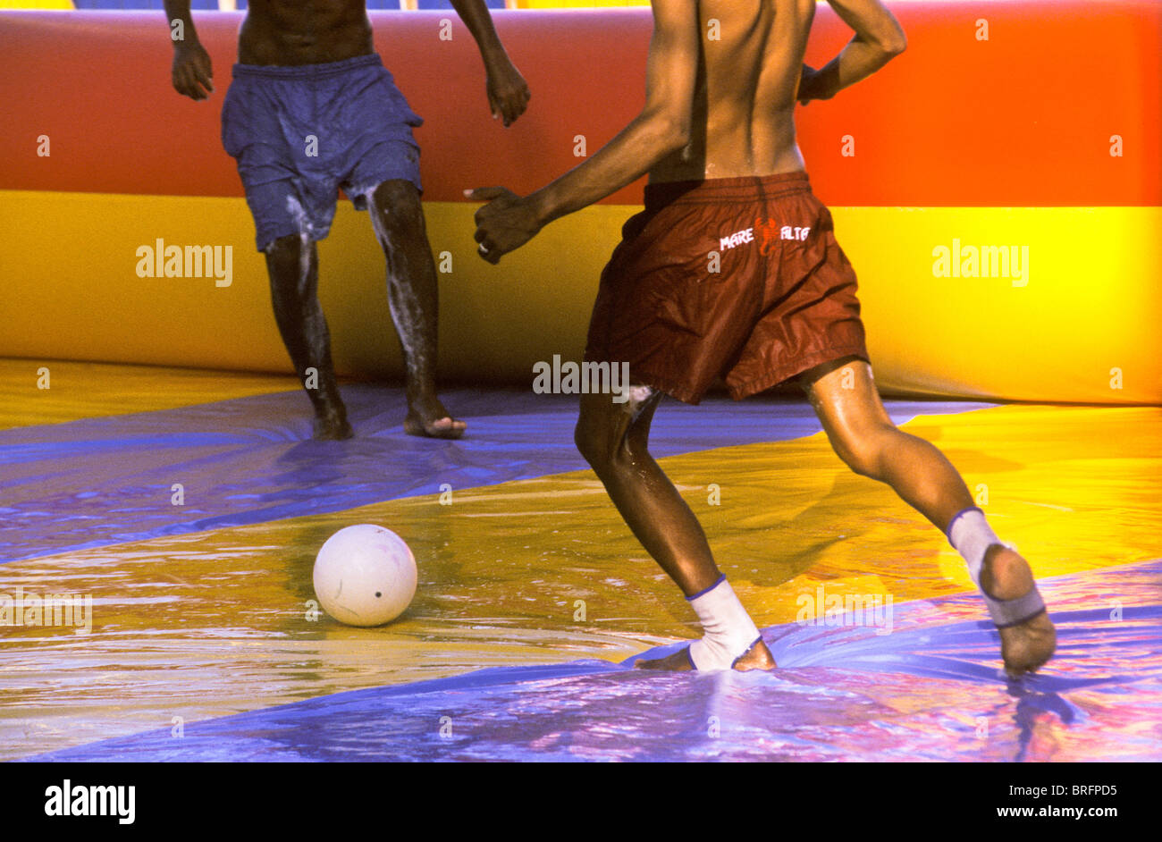 Playing "soapy football" on an inflatable pitch, Recife, Brazil Stock ...