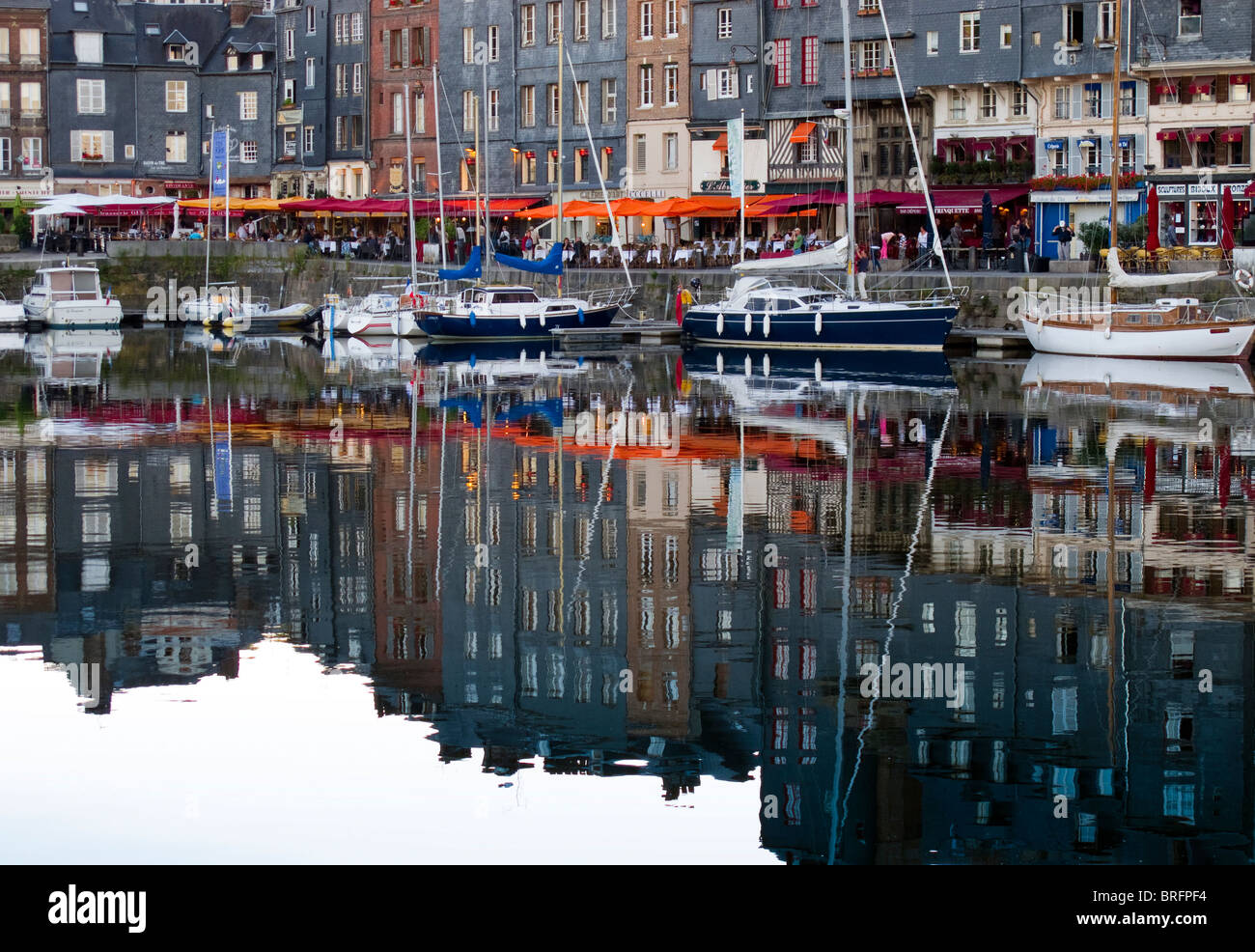 Restaurants line the quayside and yachts are moored in the port in ...