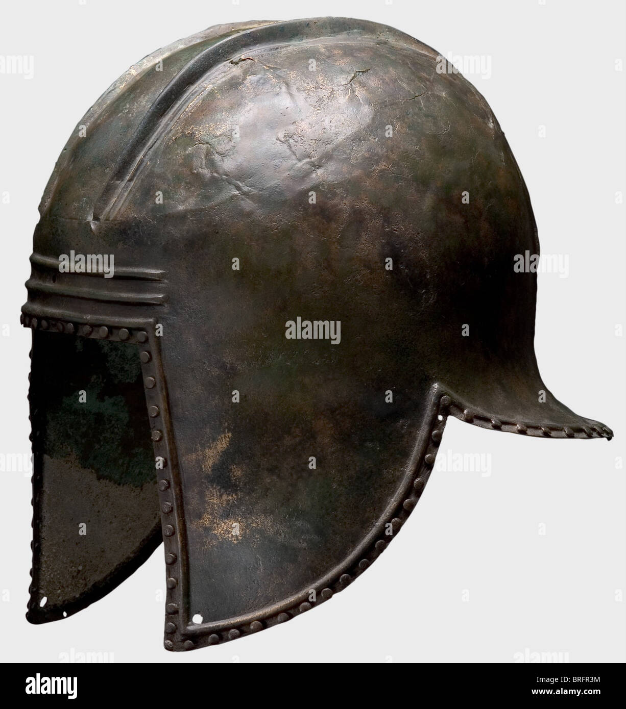 An Illyrian helmet,6th century B.C.Bronze.High-domed skull with a broad ...