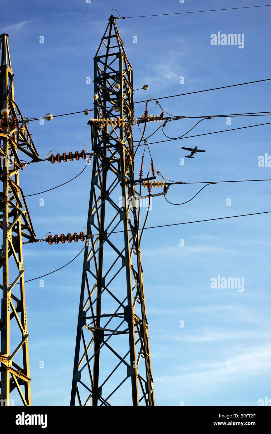 Voltage power lines and airplane Stock Photo - Alamy